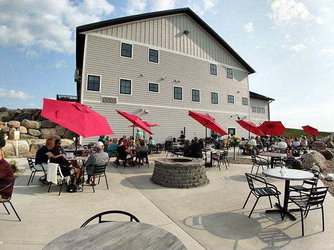 Red umbrellas dot the patio where smart people spend golden afternoons sipping wine while lesser mortals sit in traffic somewhere.