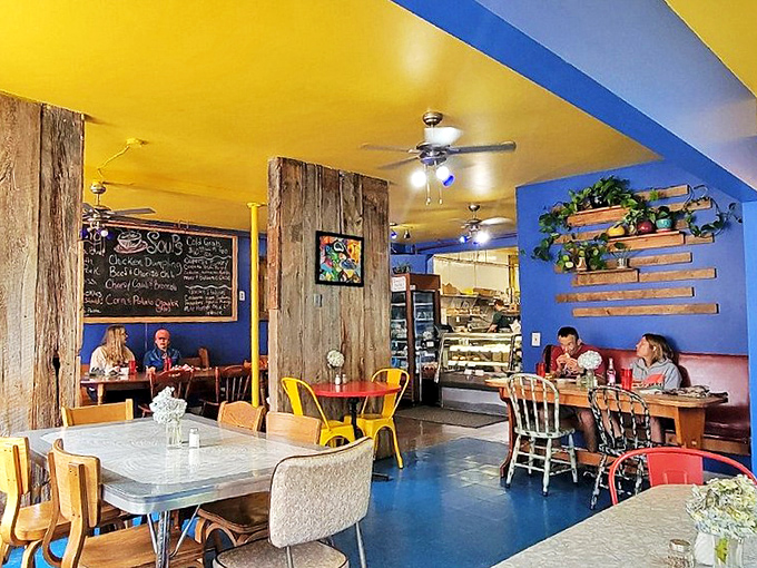 The eclectic interior brings together wooden elements, bright colors, and comfortable seating where locals and visitors mingle over exceptional food.