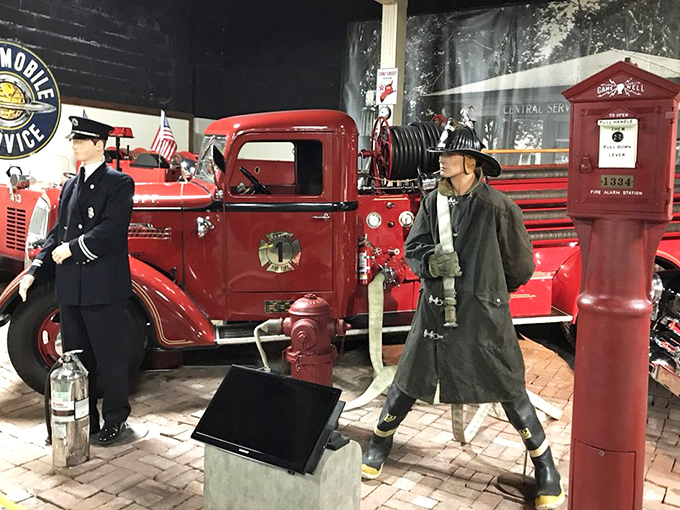 This vintage fire truck stands ready for action, its gleaming red paint and brass fittings recalling an era when firefighters hung onto the sides during emergency calls.