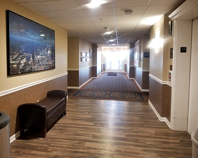 Warm woods and cool blues create corridors that feel more like a coastal home than a typical hotel passageway.