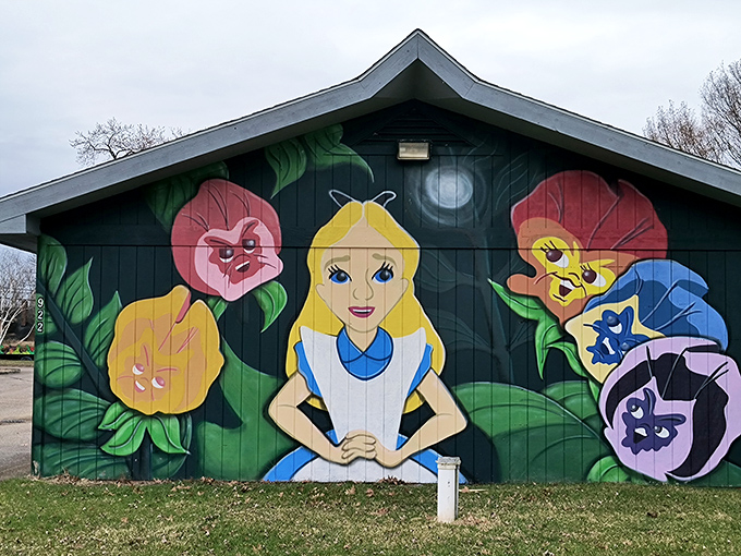 Alice in Wonderland greets visitors from this colorful mural, setting the whimsical tone for the fantasy adventure that awaits inside.