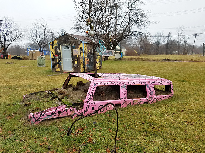 A pink vehicle returns to nature, transformed into an unlikely planter, Detroit's automotive past nurturing its green future.