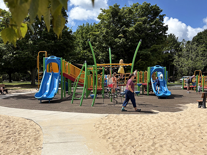 Colorful playground equipment stands ready for young adventurers to burn off energy before parents suggest "just one more hike" through the park.