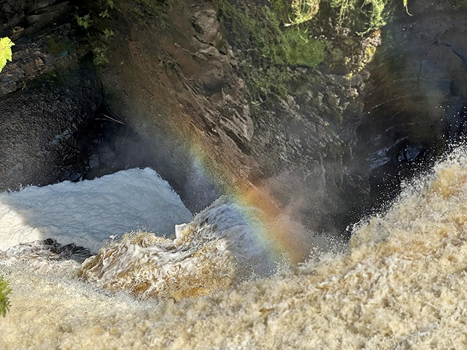 The falls' namesake phenomenon appears when sunlight kisses mist just right, creating ephemeral color arcs that seem almost too perfect to be natural.