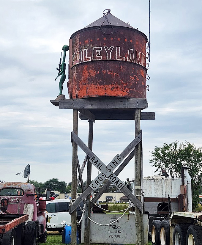 "Foleyland" proclaims this rusty water tower, standing sentinel over a kingdom of creative scrap where imagination rules with an iron fist.