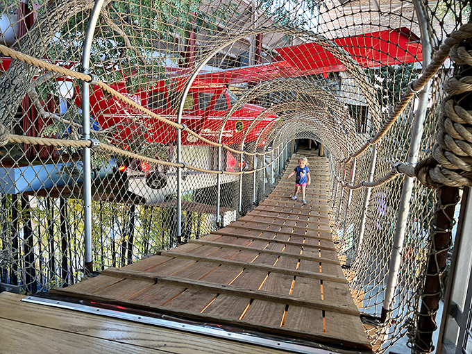 The netted climbing structure provides safe adventure for little explorers, letting them scale heights while parents watch from below&mdash;or join in the fun!
