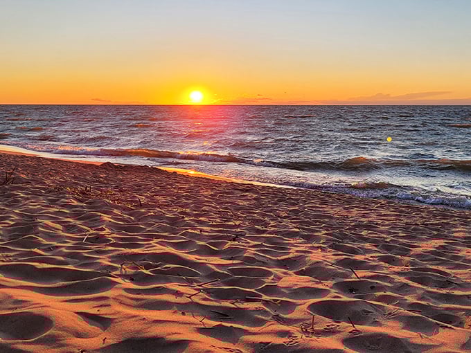 Sunset transforms Lake Huron's shoreline into a canvas of fiery colors, proving nature remains the ultimate Instagram influencer.