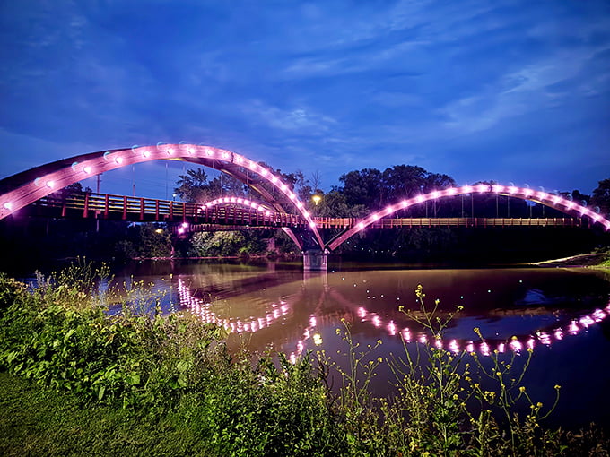 As darkness falls, twinkling lights trace The Tridge's elegant curves, creating a magical nighttime reflection that doubles the enchantment.
