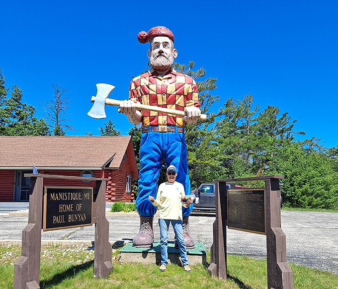 Visitors gain perspective standing beside the massive lumberjack, creating the perfect souvenir photo of their Upper Peninsula adventure.