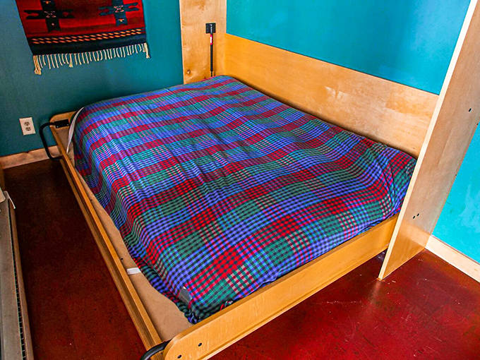 Colorful bedding brightens this cozy sleeping nook, where dreams are influenced by the gentle lapping of nearby waves.