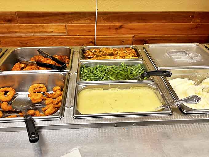 The buffet line offers a parade of homestyle favorites, where steam rises from trays of comfort foods prepared with decades of experience.