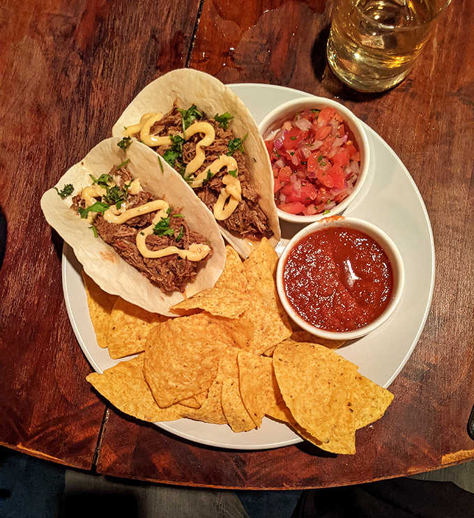 Carnitas Tacos: Slow-cooked perfection nestled in soft tortillas, accompanied by house-made salsa that brightens each flavorful bite.