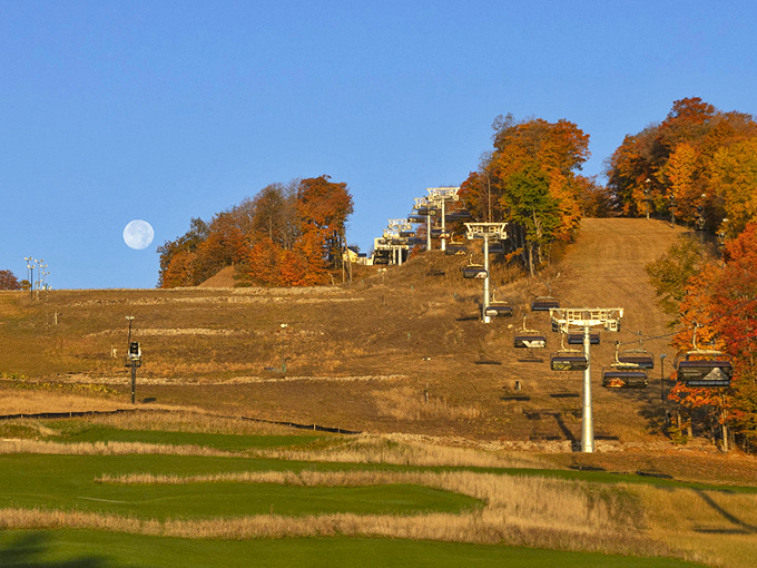 Autumn paints The Highlands in spectacular colors as chairlifts stand ready against a backdrop of fiery foliage and harvest moon.