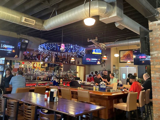 The bar area serves as both waiting space and destination, where sports fans gather and strangers become friends over shared cheers.