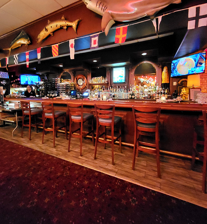 The bar area invites seafood lovers to belly up for stories and spirits under international maritime flags.