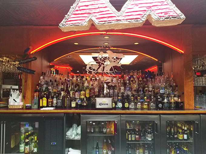 The bar area glows with neon warmth&mdash;shelves stocked with premium tequilas and mezcals promising adventures in agave appreciation.