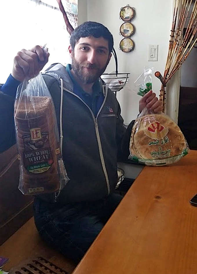 The universal expression of bakery happiness &ndash; a satisfied patron clutching their paper bag of goodies, already planning their next visit before leaving.