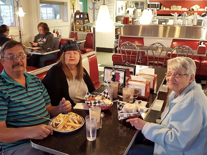 Happy diners enjoying the fruits of Don's culinary labor – those smiles tell you everything you need to know about the food.