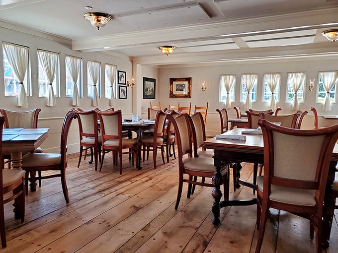Wide-plank floors and abundant natural light create a dining space where history and comfort meet, making everyday meals feel like special occasions.