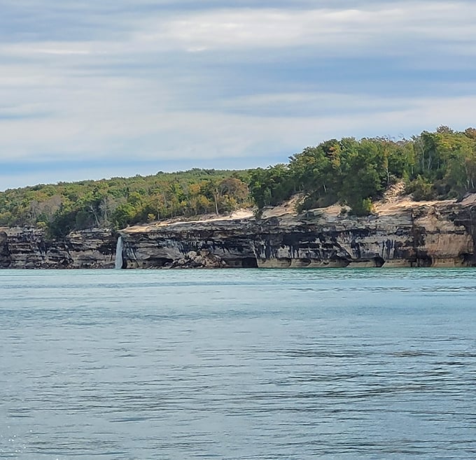 Sandstone cliffs stretch toward the horizon, their layers telling geological stories older than human history itself.