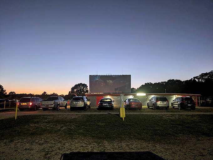 Cars gather like modern-day covered wagons, forming a temporary community united by their love of stories told large under open skies.