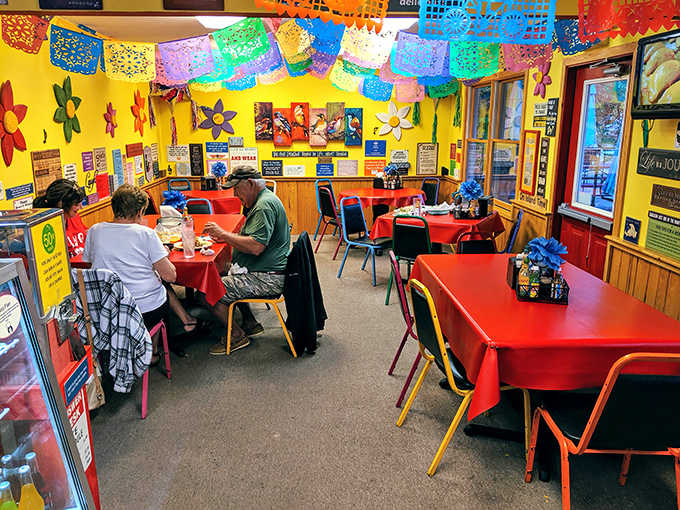 Every surface tells a story in the dining area, where mismatched chairs and vibrant decorations create a space that feels personally curated.
