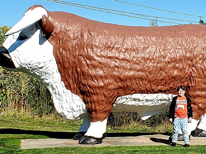 This magnificent bovine statue stands as the unofficial guardian of dairy delights, dwarfing children and adults alike.
