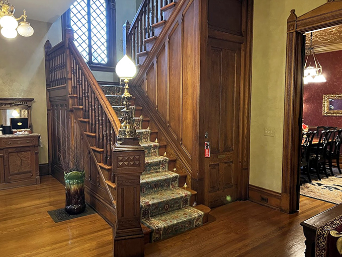 Grand Staircase Foyer: Polished banisters and carpeted steps lead upward with such grandeur you'll want to make an entrance every time you descend.
