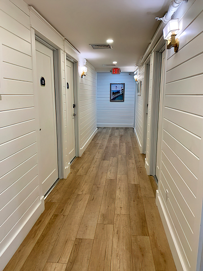Guest Room Hallway: Crisp white shiplap guides you down hallways where each door opens to a different version of island-inspired comfort.