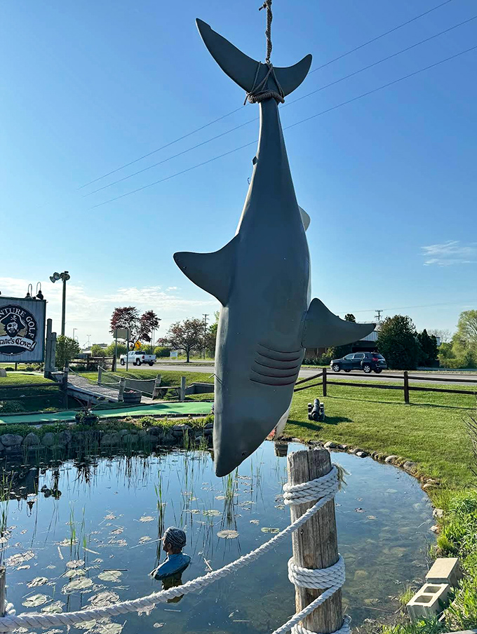 This suspended shark serves as both impressive decoration and silent warning to those who might consider fishing their ball out of the water hazard.