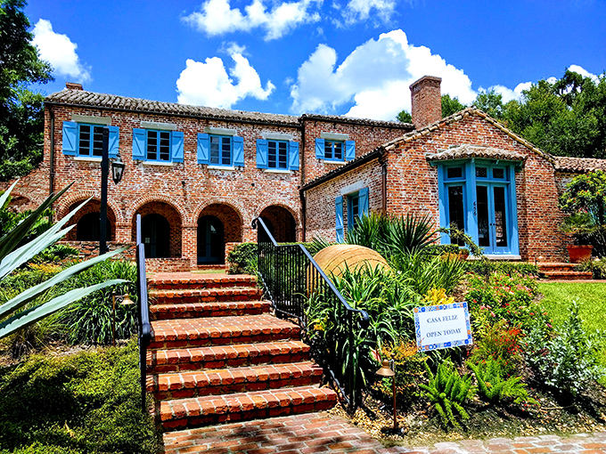 The exterior showcases Mediterranean Revival at its finest, all terra cotta tiles and brick walls that have earned every bit of their character.