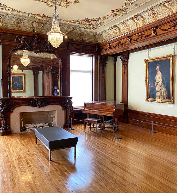 The grand piano sits patiently in a room where ornate woodwork and crystal chandeliers create acoustics that would make Mozart weep with joy.