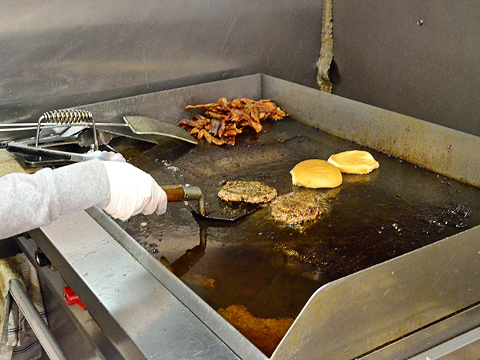 The open kitchen reveals no secrets &ndash; just the timeless choreography of burger craftsmanship performed by experts who've mastered their art.