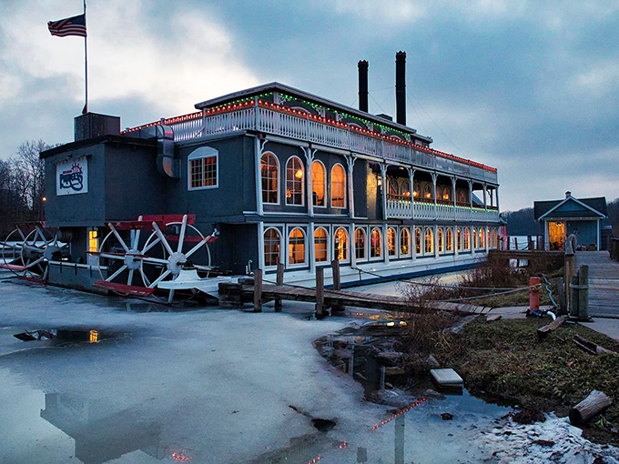 Docked and ready for boarding, the riverboat's distinctive silhouette stands out against the twilight sky.