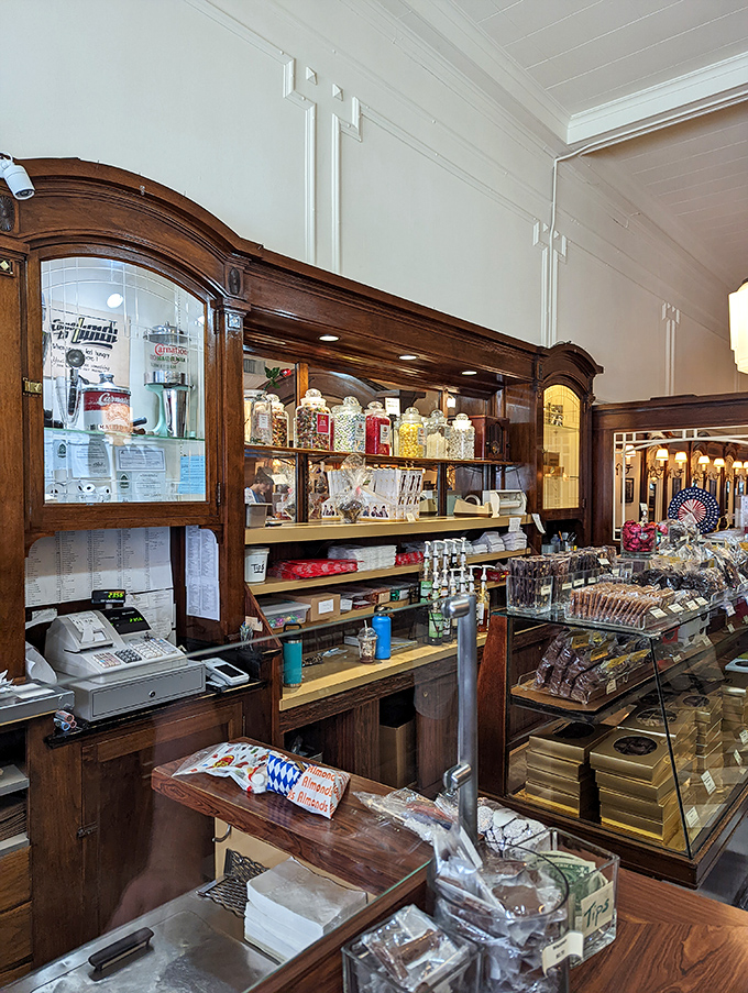 Behind this wooden sentinel, generations of servers have orchestrated countless moments of joy – one scoop, sandwich, and smile at a time.
