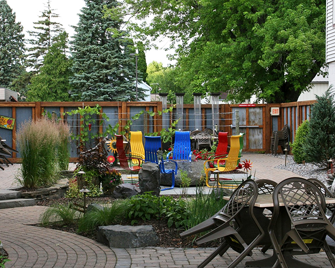 Prairie Pond's colorful patio chairs invite lingering conversations and lazy afternoon refreshments in a garden setting that feels wonderfully European.