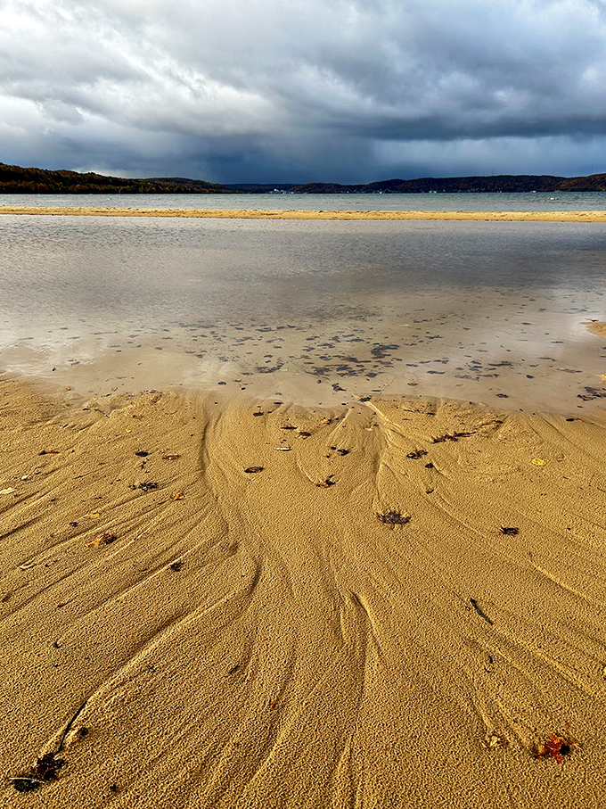 The sand here holds footprints and stories, each ripple and pattern created by wind and water working together like nature's abstract artists.