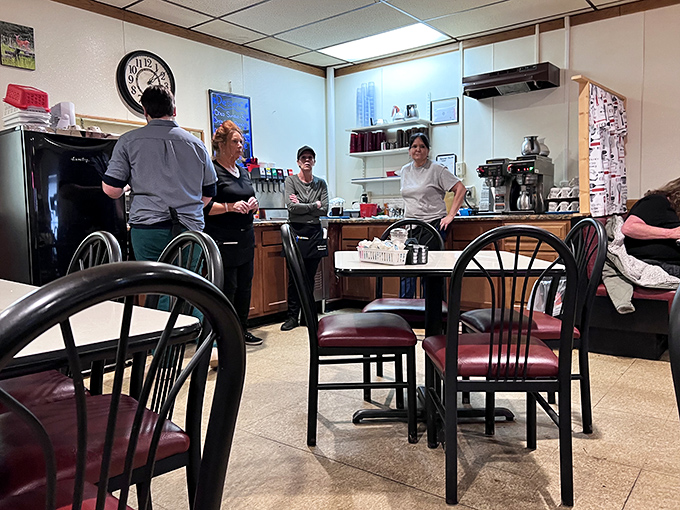 The kitchen crew moves with choreographed precision, turning out plate after plate of comfort food that keeps the community coming back.