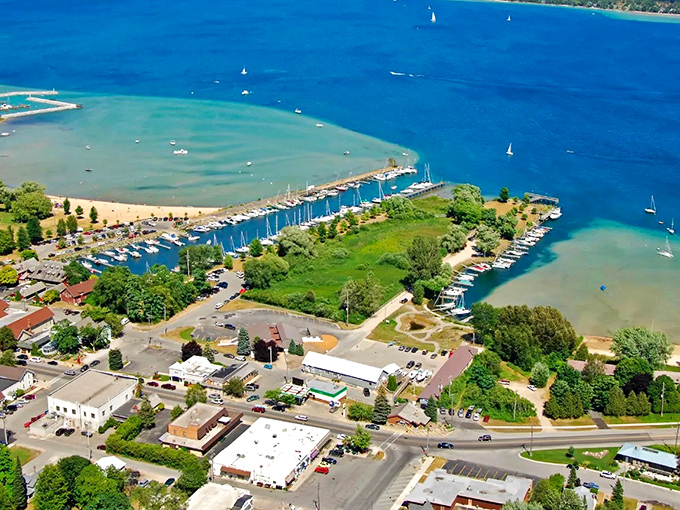 Suttons Bay marina creates a perfect postcard scene where sailboat masts stand like exclamation points against the blue waters of Grand Traverse Bay.