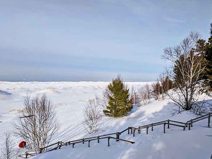 Winter transforms Twelvemile Beach into a snow-globe wonderland where Lake Superior's waves freeze mid-crash in sculptural perfection.