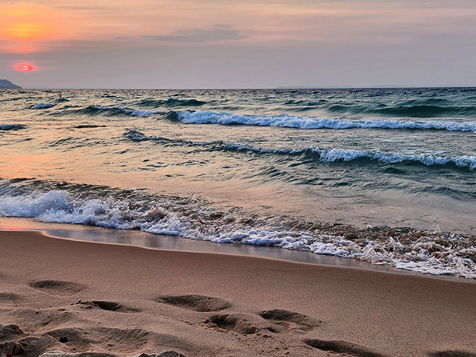 Waves gently caress the shore in hypnotic rhythm, nature's own meditation soundtrack set against a canvas of golden sand.