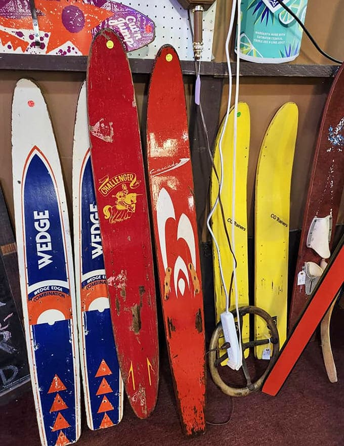 Vintage wooden water skis lean against the wall like retired athletes, their faded colors telling tales of Minnesota summers and lake adventures past.