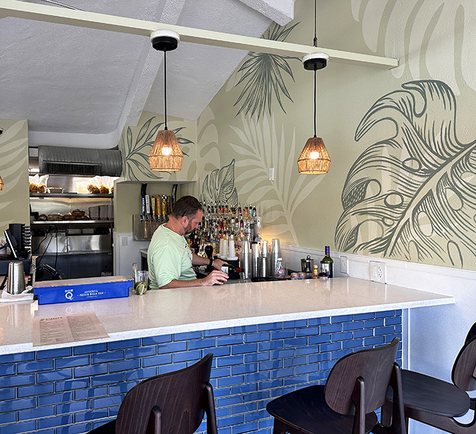 The bartender's domain: where tropical wall art meets mixology magic. Your vacation stories start here, whether you remember them or not.