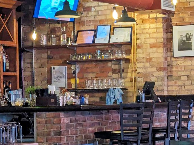 The bar area showcases Michigan's craft beverage scene, with knowledgeable staff ready to guide your pizza pairing adventure without a hint of pretension.