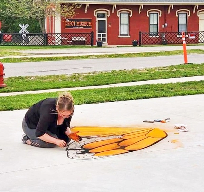 Sidewalk butterflies take flight under an artist's careful hand, transforming ordinary concrete into a canvas for winged beauty.