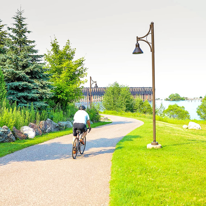 A cyclist glides along Marquette's waterfront, where industrial history and natural splendor create the perfect backdrop for two-wheeled adventures.