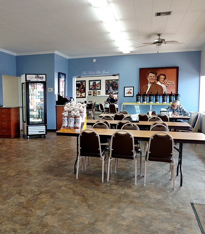 The dining area's blue walls and simple furnishings create a homey backdrop for countless conversations, celebrations, and everyday moments.