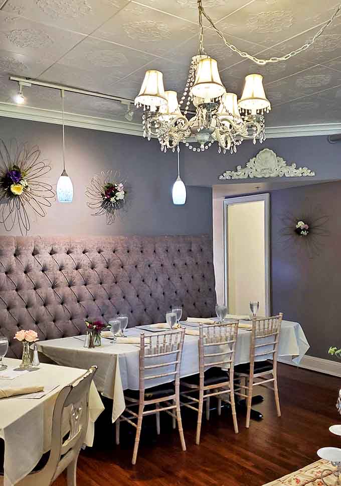Lavender walls, tufted banquettes, and crystal chandeliers create a dining space that's equal parts Victorian parlor and modern Instagram dream.