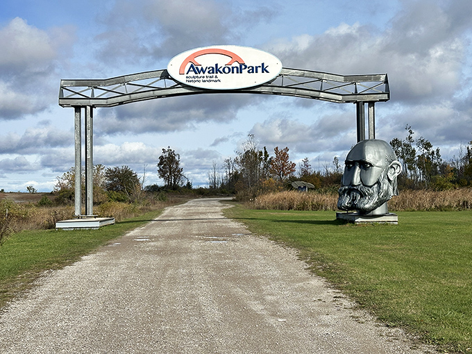 The entrance to Awakon Park promises visitors they're about to experience something uniquely Michigan – where else would giant metal heads guard a sculpture trail?