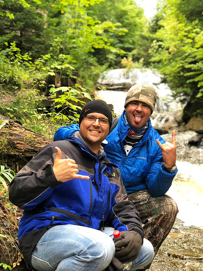 Happy hikers celebrate their arrival at the falls &ndash; because some views are better shared with friends who appreciate a good adventure.